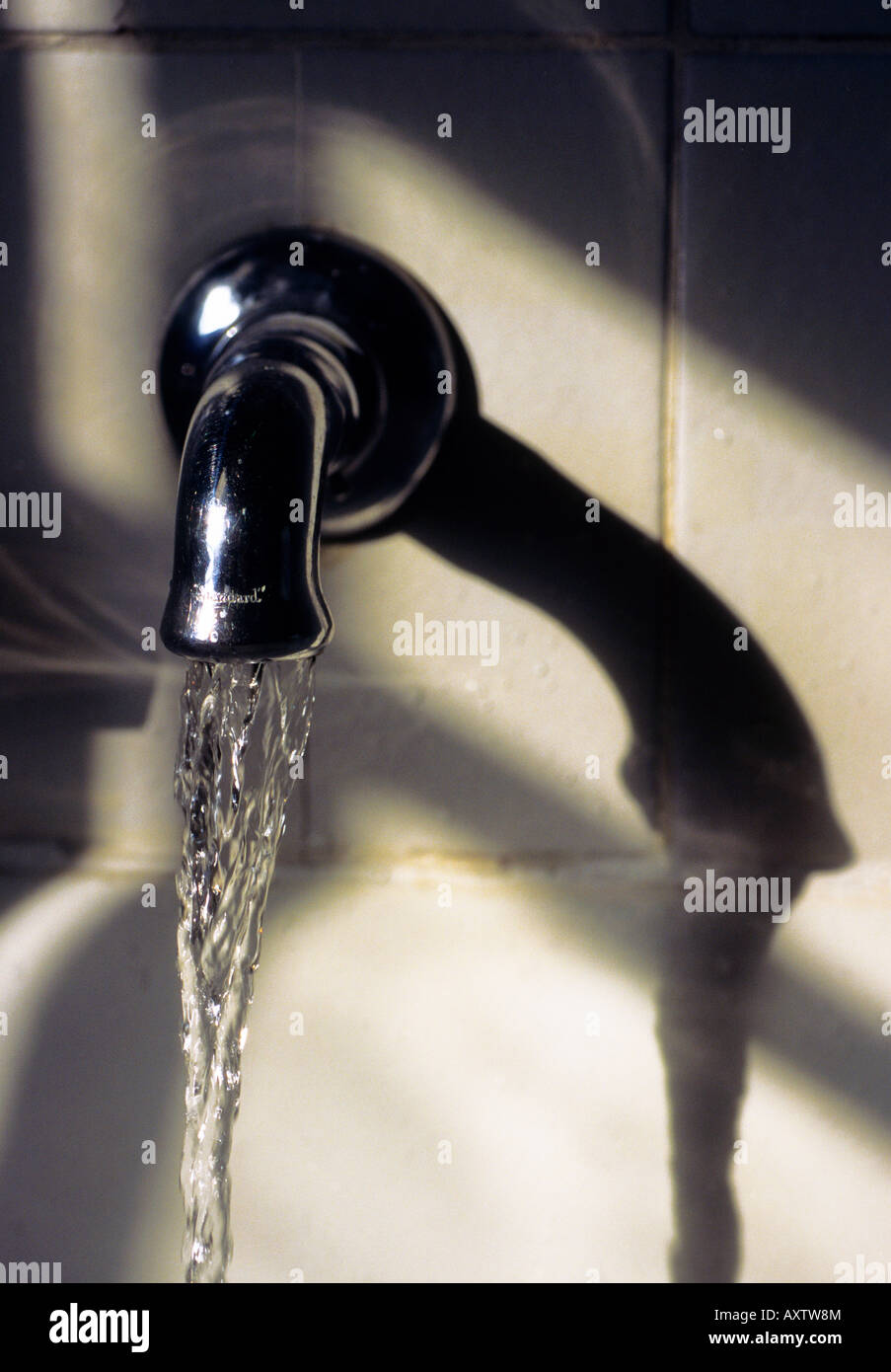 Faucet. Bathroom fixture with water turned on. Plumbing. Running water ...