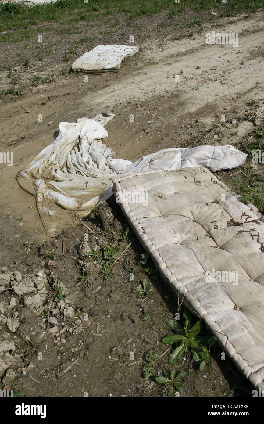 dirty bedding abandoned in field Stock Photo - Alamy