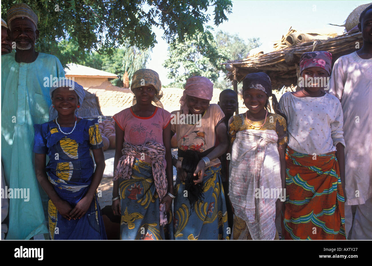 group shot of five smiling nigerian girls from the north flanked by a ...