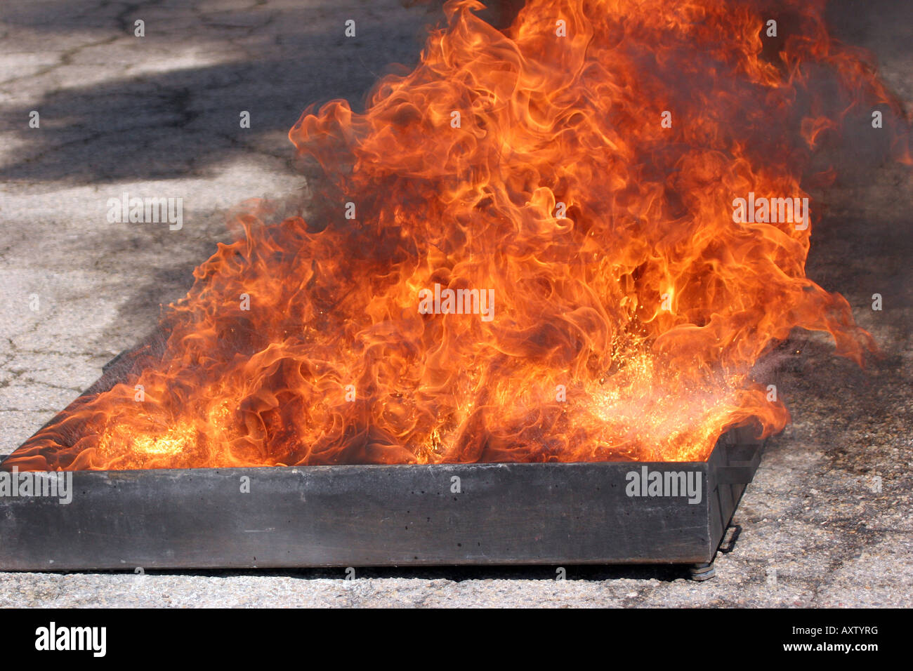 A pan with fuel on fire at a Fire Fair Safety Demonstration Stock Photo ...