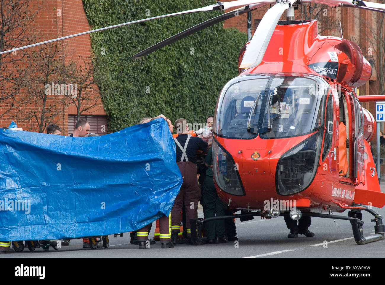Emergency services personnel preparing road traffic accident victim for ...