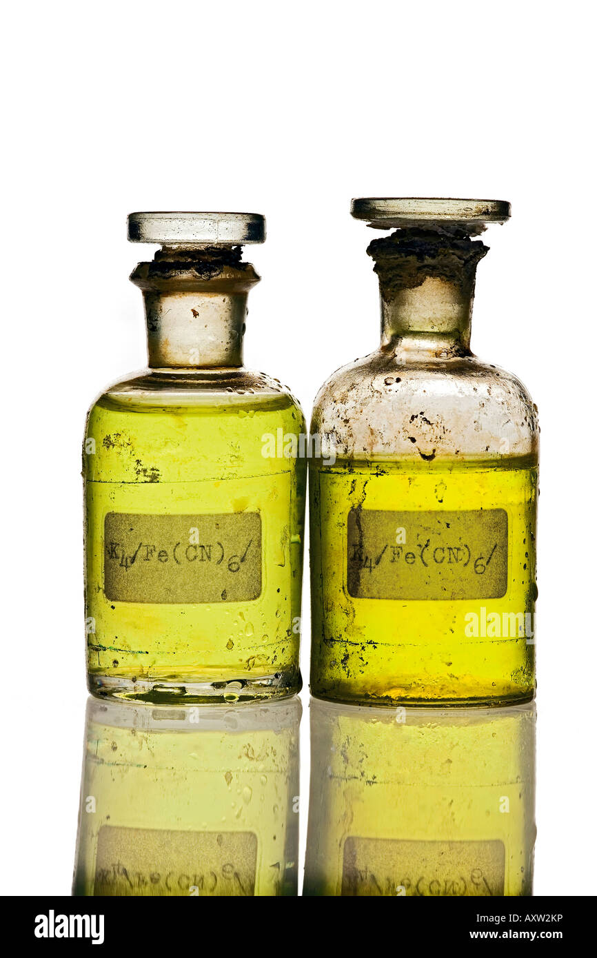 two old laboratory bottles filled with yellow liquid Stock Photo - Alamy
