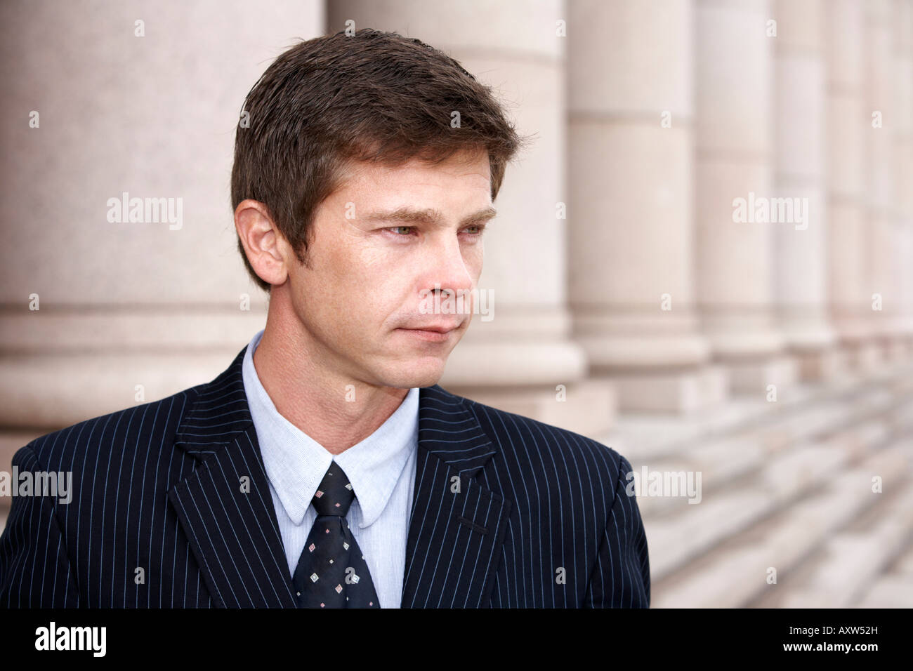 Portrait of man by pillars and steps of building Stock Photo - Alamy