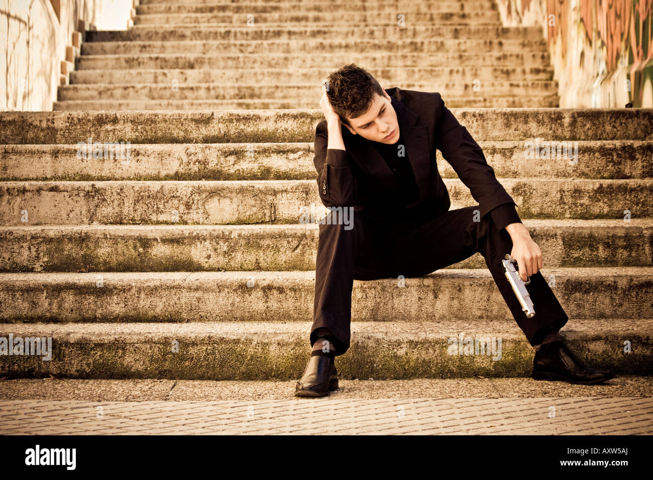 Young man waiting on steps hi-res stock photography and images - Alamy
