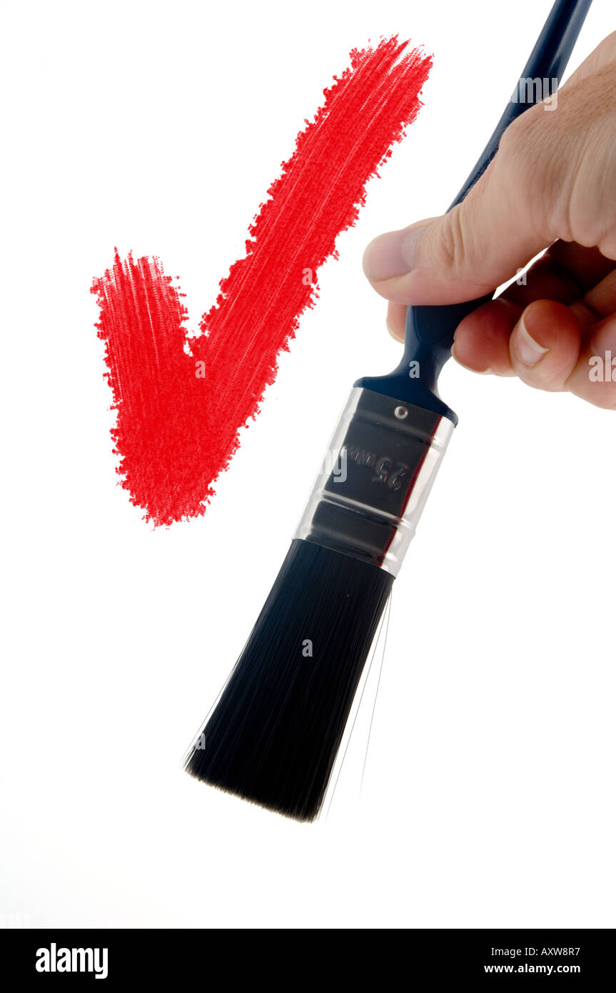 hand with paintbrush painting a tick Stock Photo - Alamy