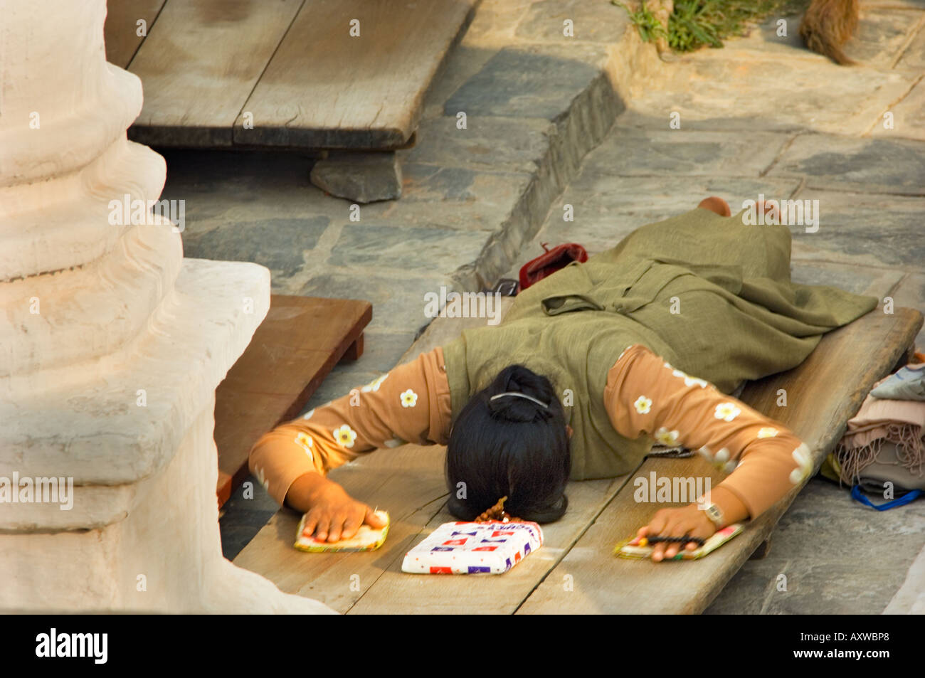 pilgrim stretching out himself pray praying at STUPA of Bodhnath ...
