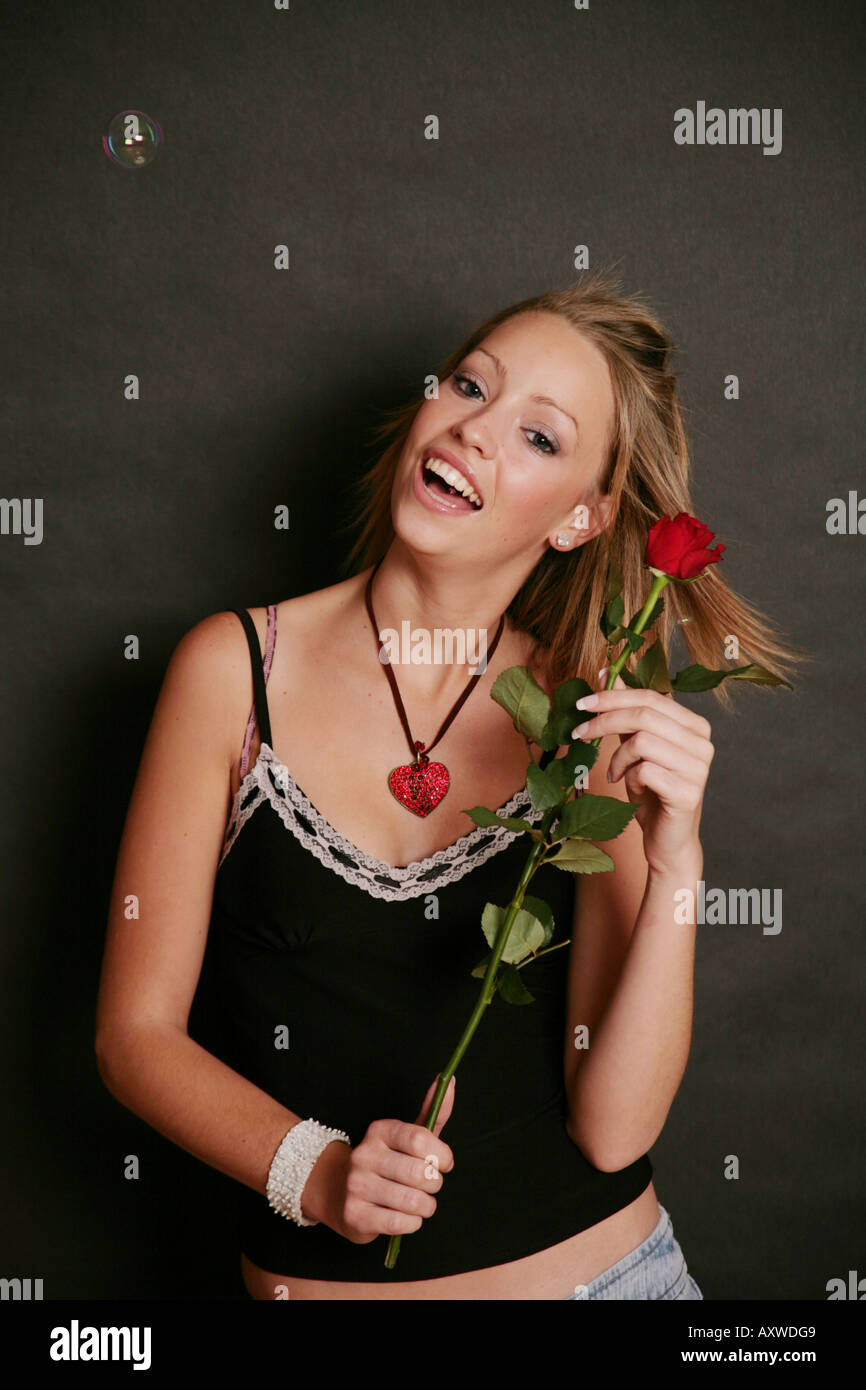 Happy laughing girl with red rose as a fashion shot Stock Photo - Alamy
