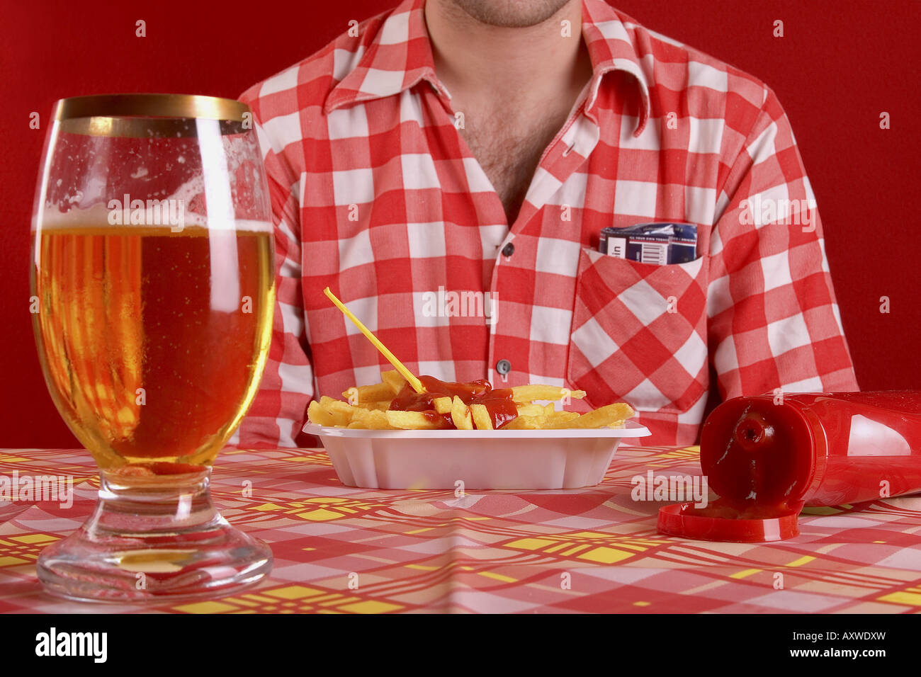 man with french fries, ketchup and beer glass Stock Photo - Alamy
