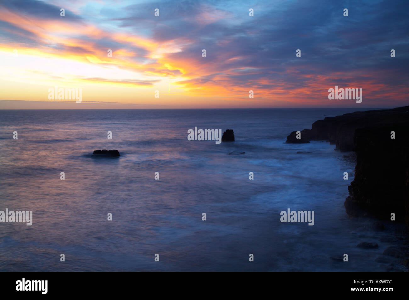England, Tyne and Wear, Marsden Bay. Sunrise over the North Sea, near ...