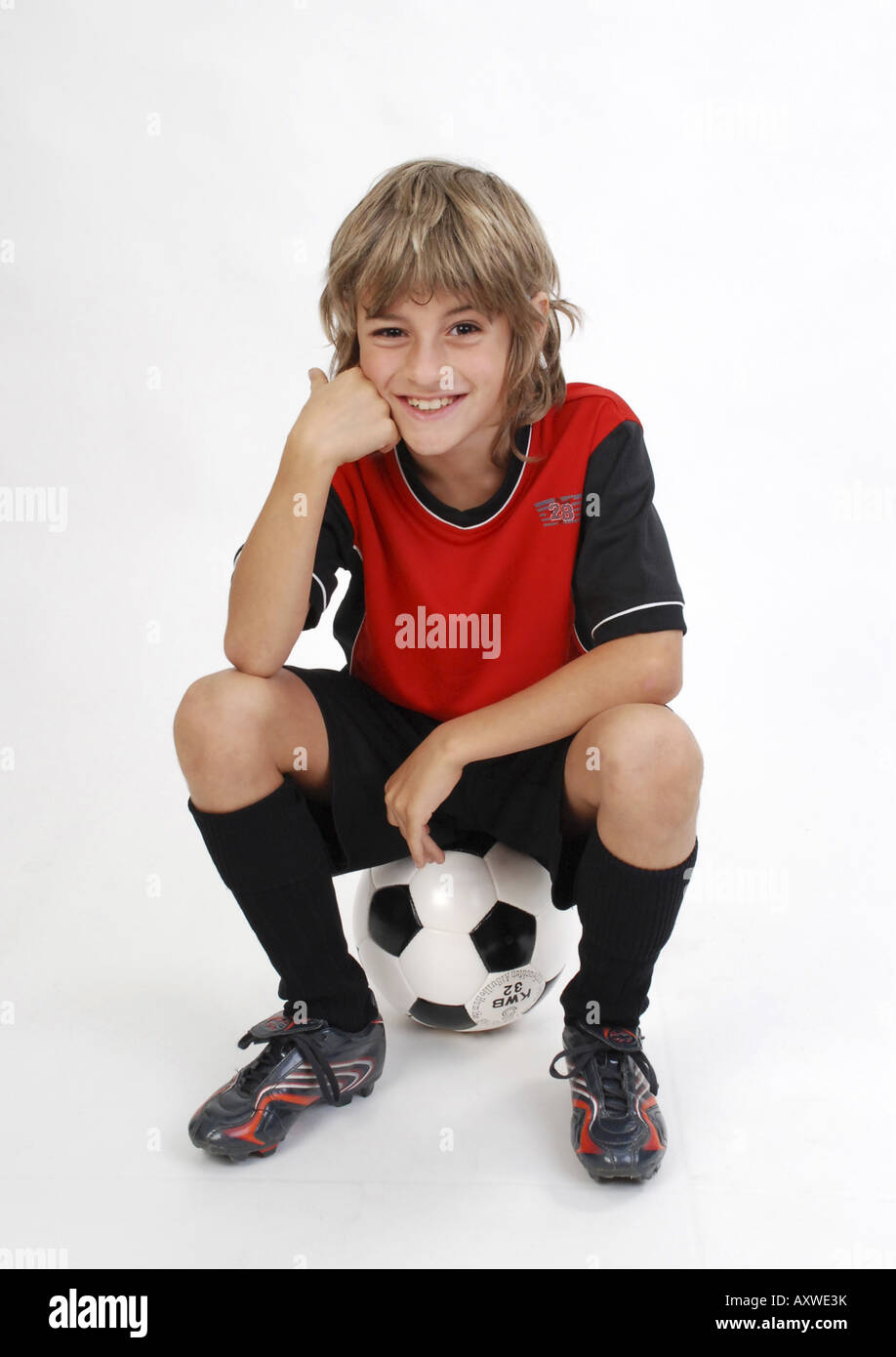 boy sitting on a football Stock Photo - Alamy