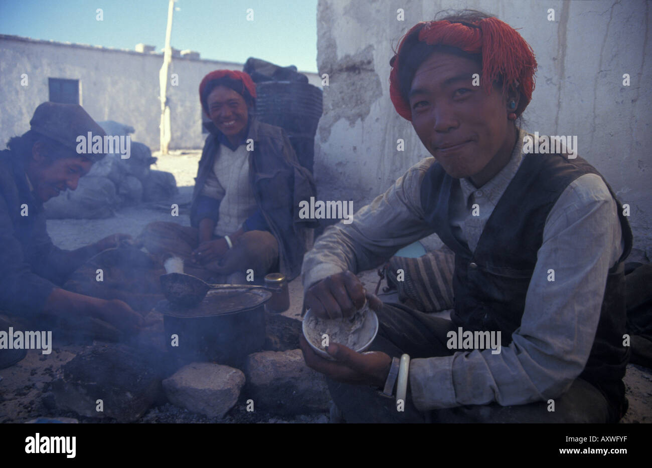 Tibetans Khampa men mixing tsampa for lunch Tibetan Plateau Tibet China ...