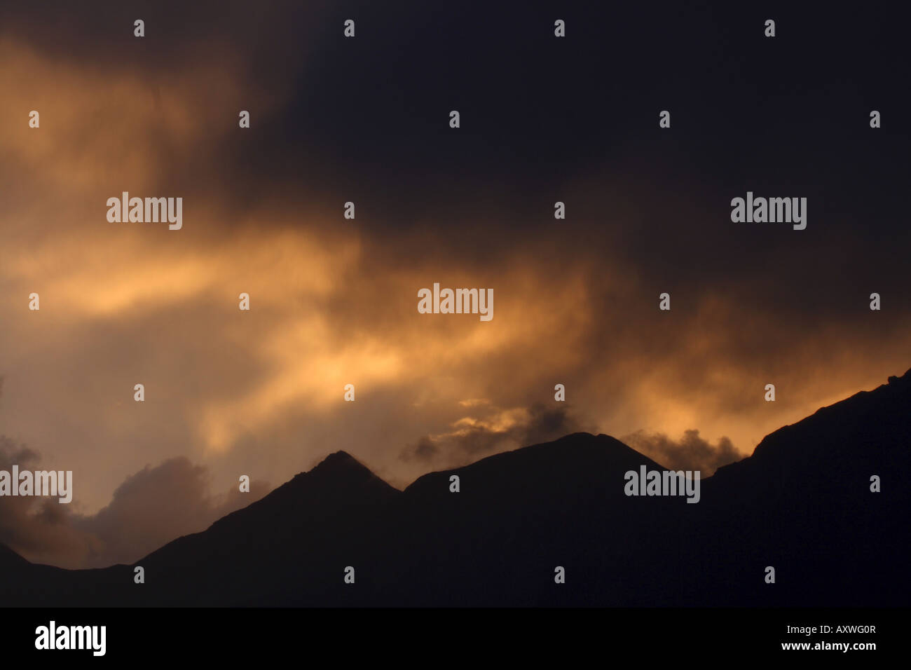sunset at stormy atmosphere over the Rocky Mountains, Canada, Alberta ...