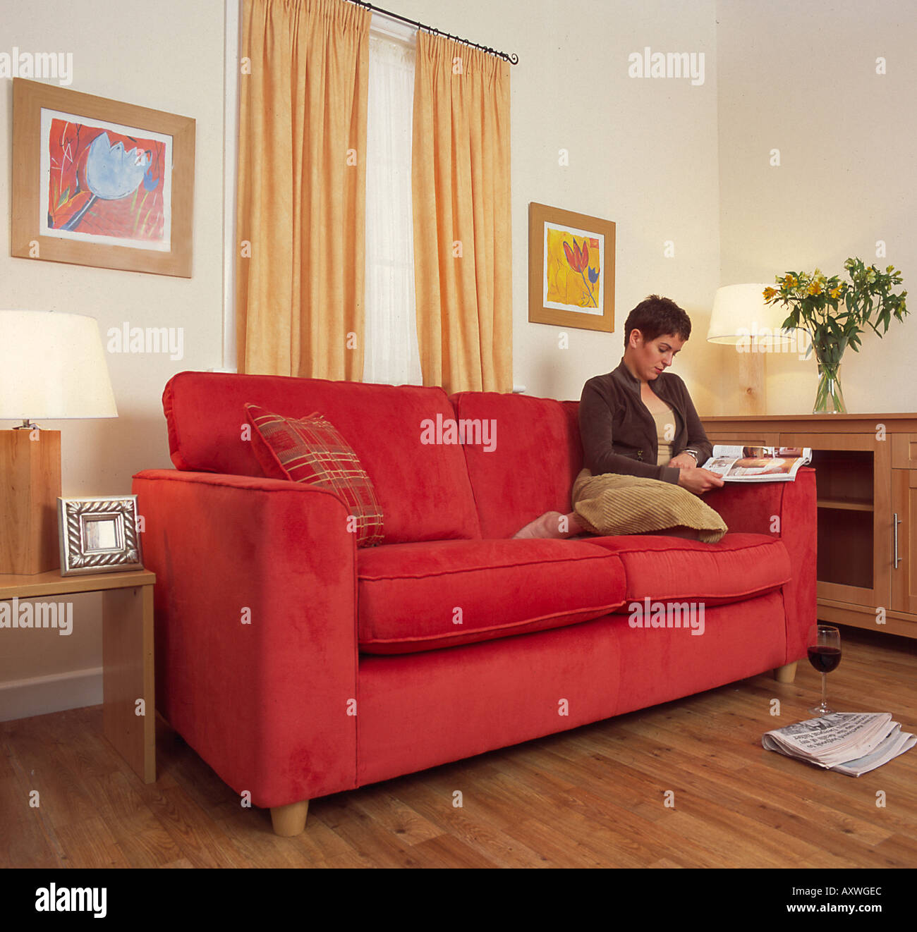 Red Settee with female model Stock Photo - Alamy