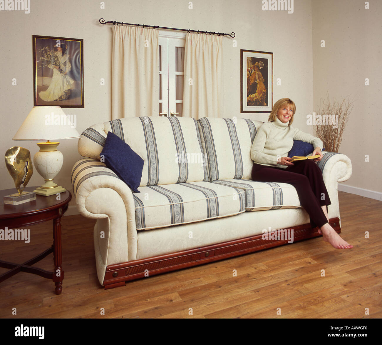 Woman sitting on Settee Stock Photo - Alamy