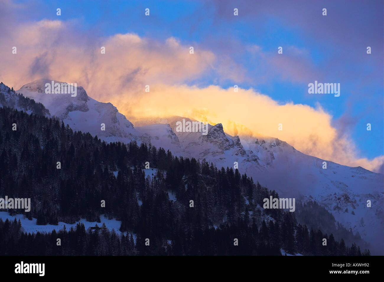 Clouds over mountain peak Stock Photo - Alamy