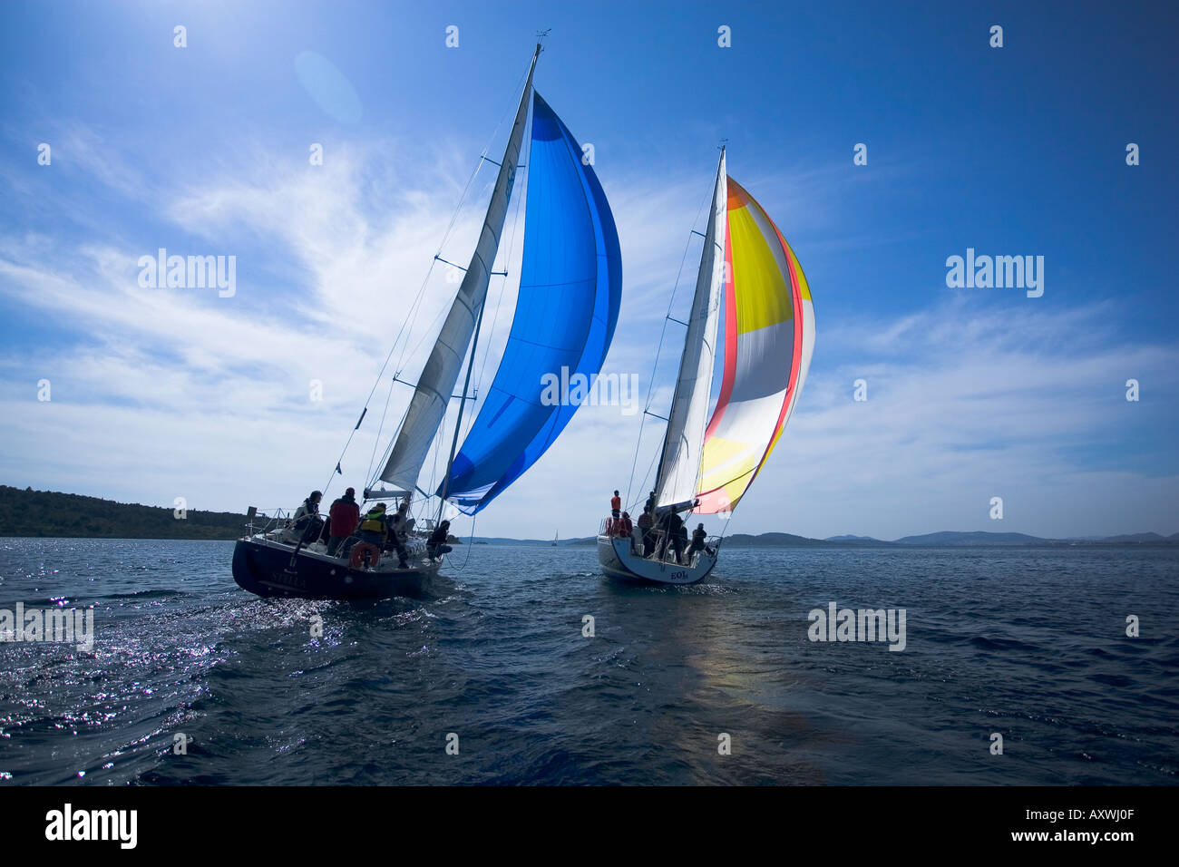 Two cruiser sailing boats racing each other downwind, with main sails ...