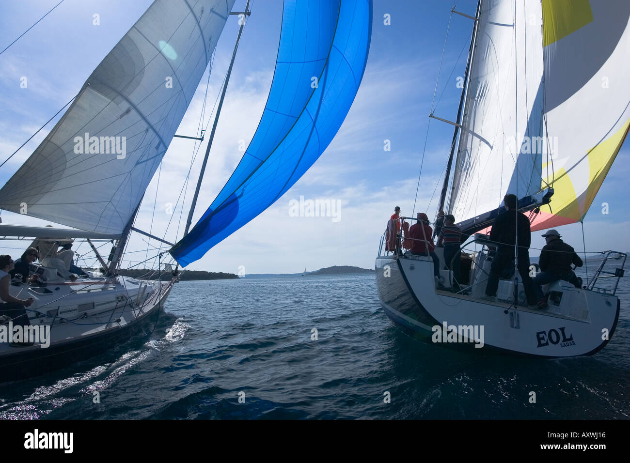 Two cruiser sailing boats racing each other downwind, with main sails ...