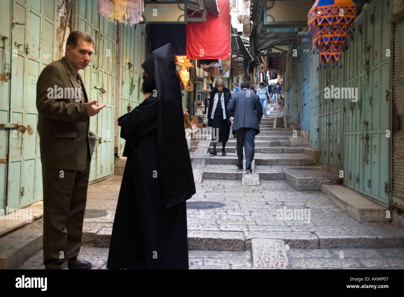 Man and Priest in Jerusalem Arab market street Stock Photo - Alamy