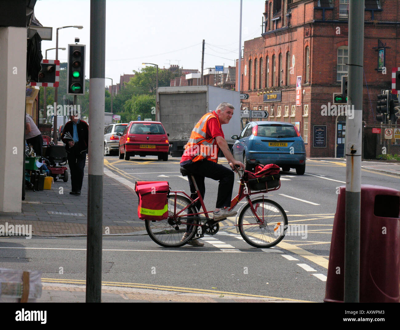 Postman on his bicycle hi-res stock photography and images - Alamy
