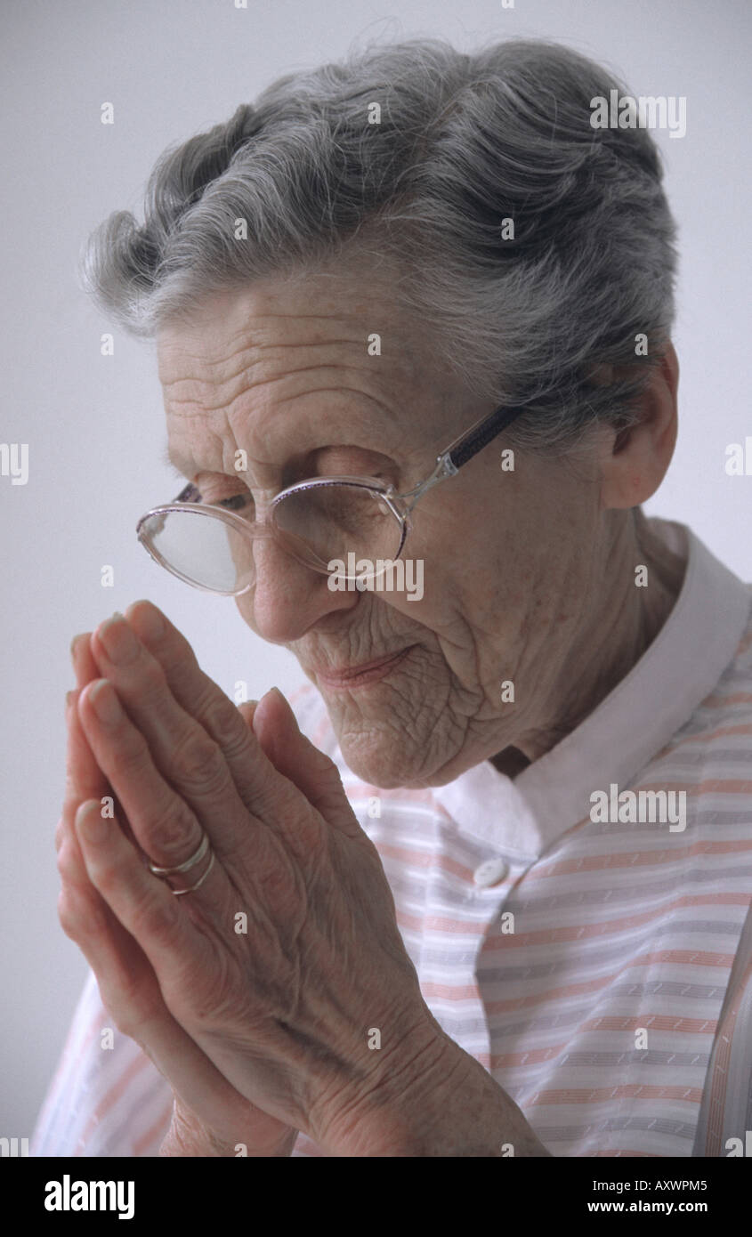 elderly woman praying Stock Photo - Alamy