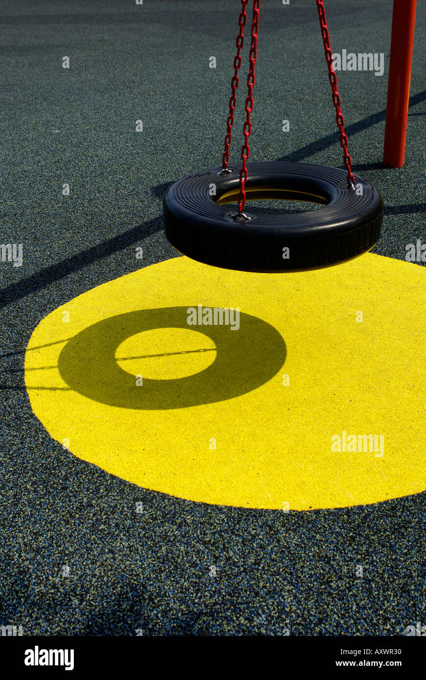 Playground tire swing with yellow safety circle Stock Photo - Alamy