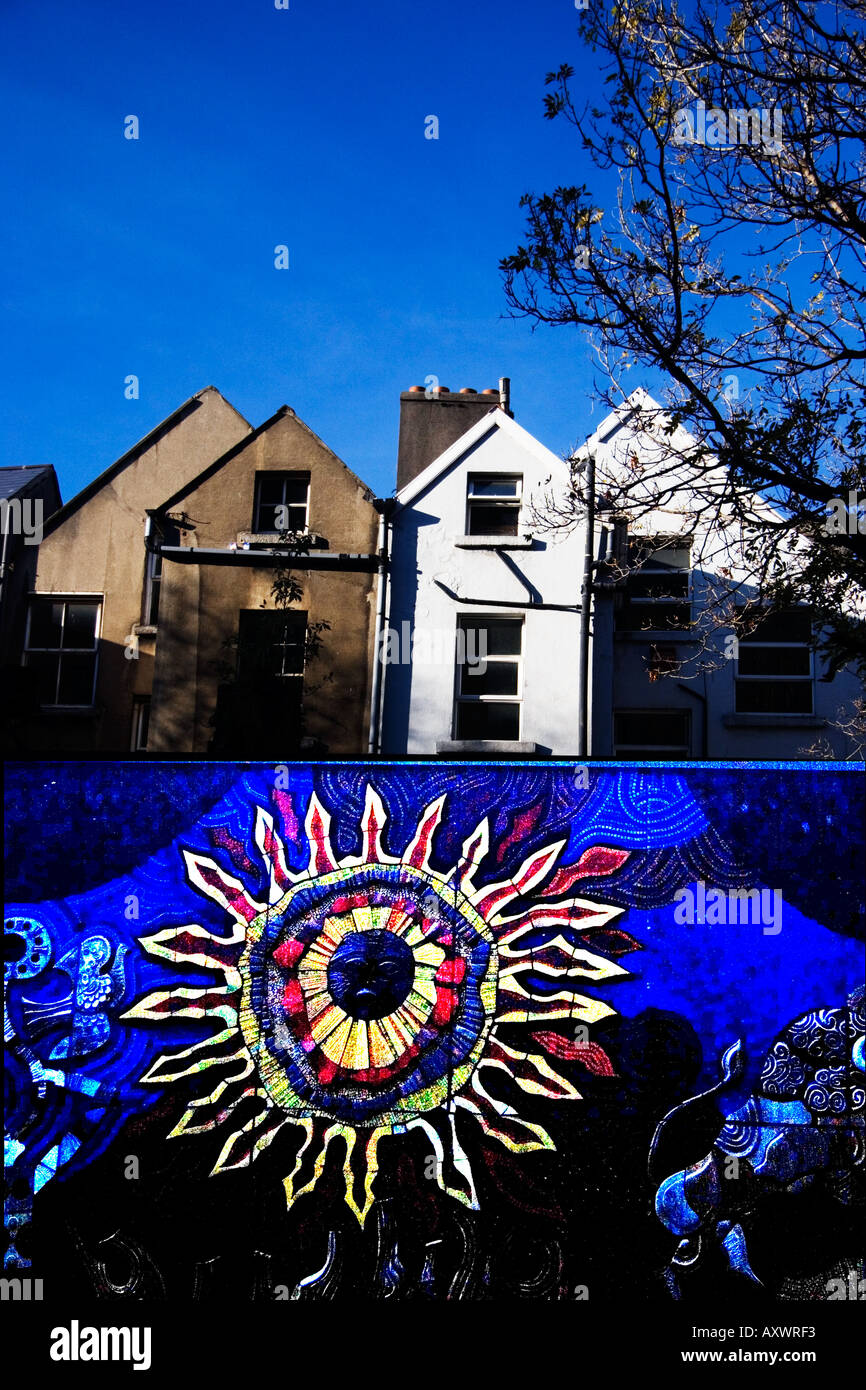Decoratively tiled wall in front of a row of houses Dublin Ireland ...