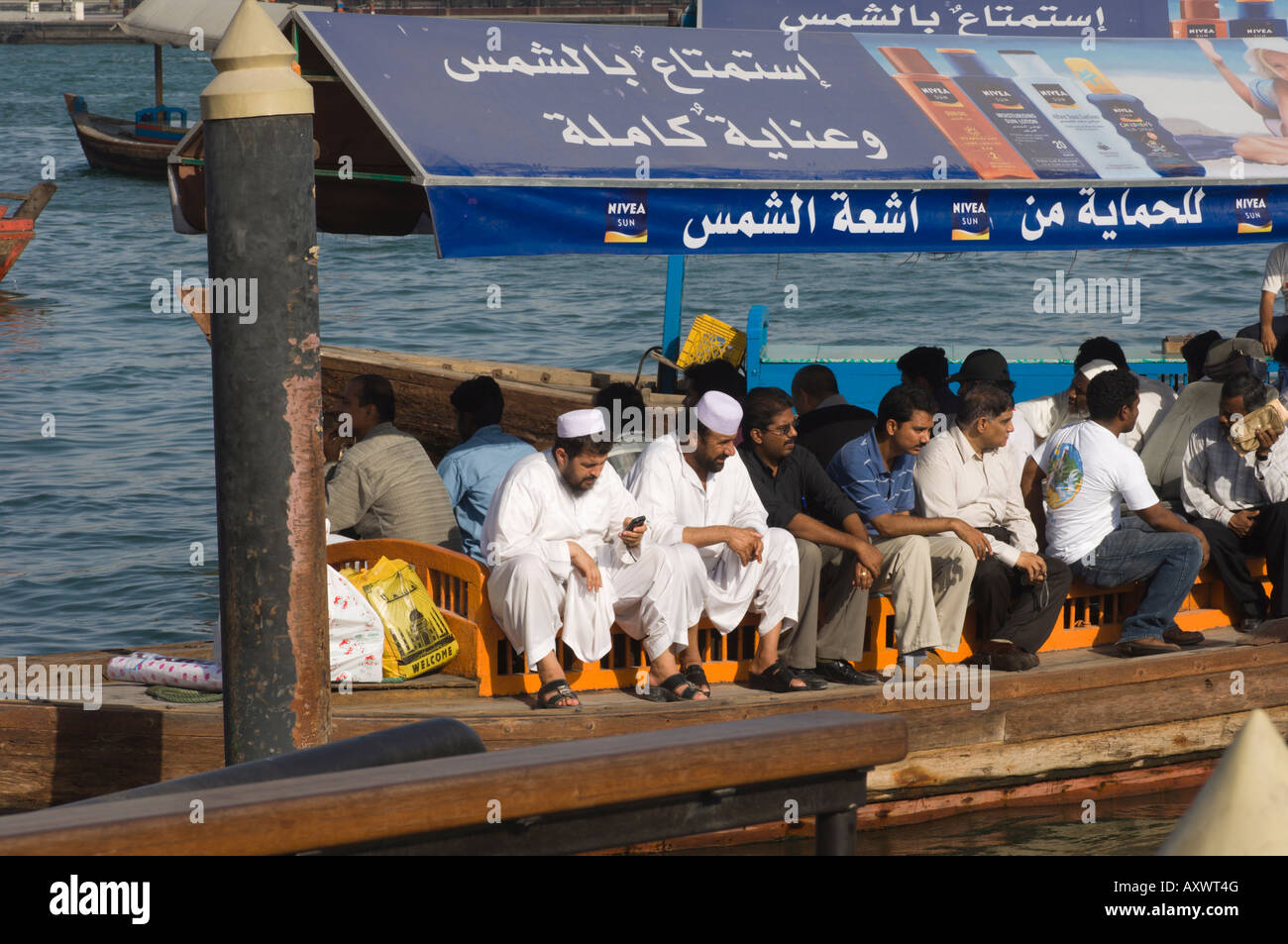 Passangers on an abra, the small ferries that cross Dubai Creek, Dubai ...