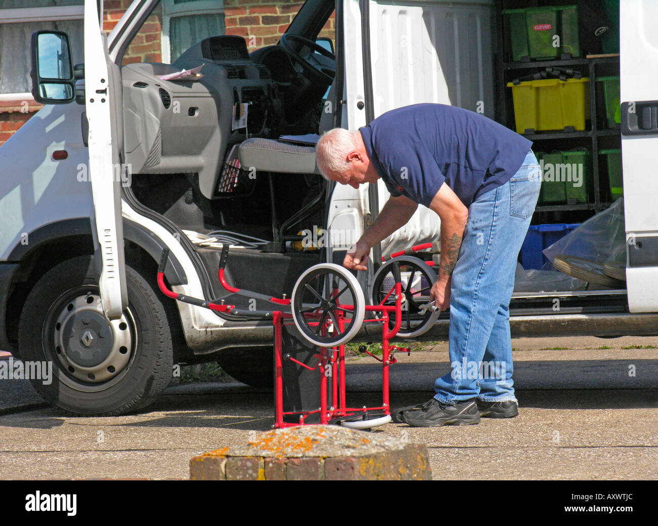 elderly man repairing and mending a wheelchair Stock Photo - Alamy