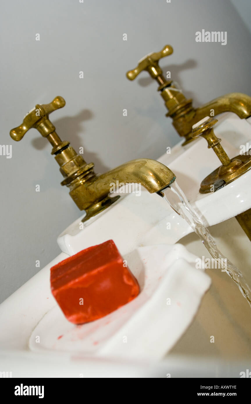 old victorian bath taps running water and a bar of soap Stock Photo - Alamy