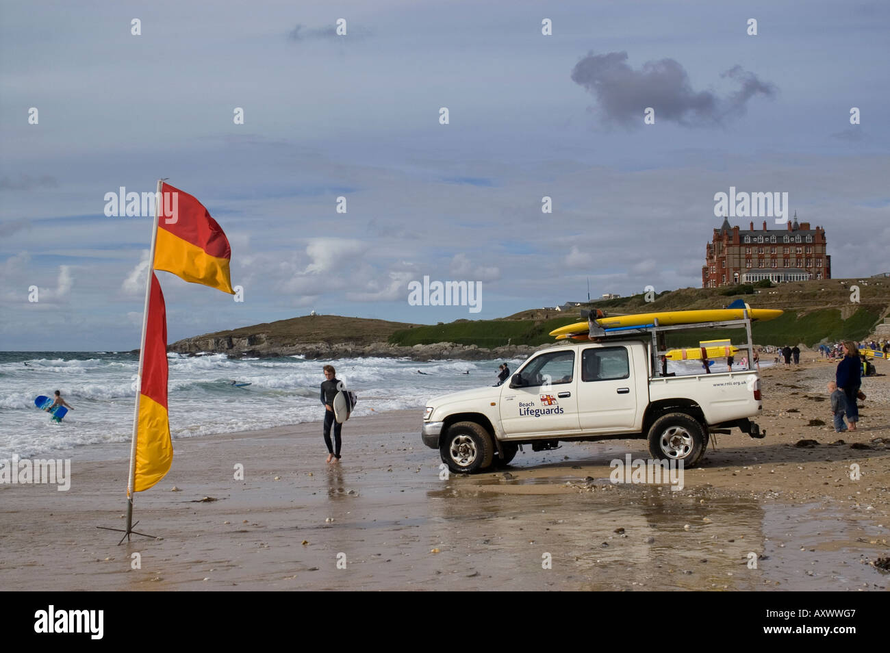 Lifeguard vehicle and red and orange marker flags on Fistral Beach ...