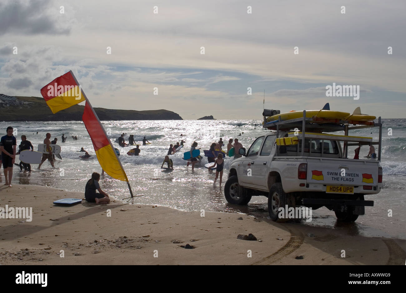 Lifeguard vehicle and red and orange marker flags on Fistral Beach ...