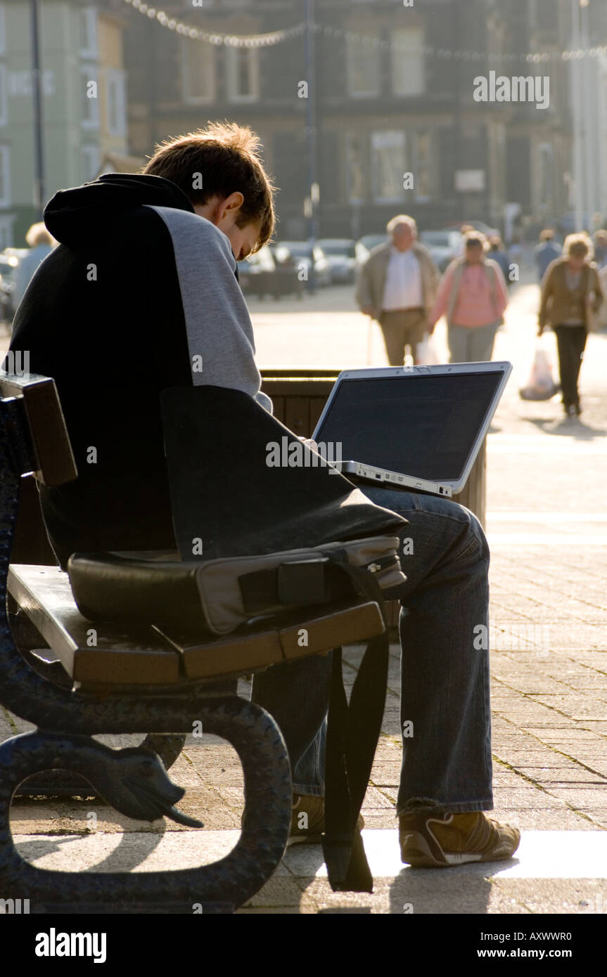 man accessing free public wireless internet network connection on his ...