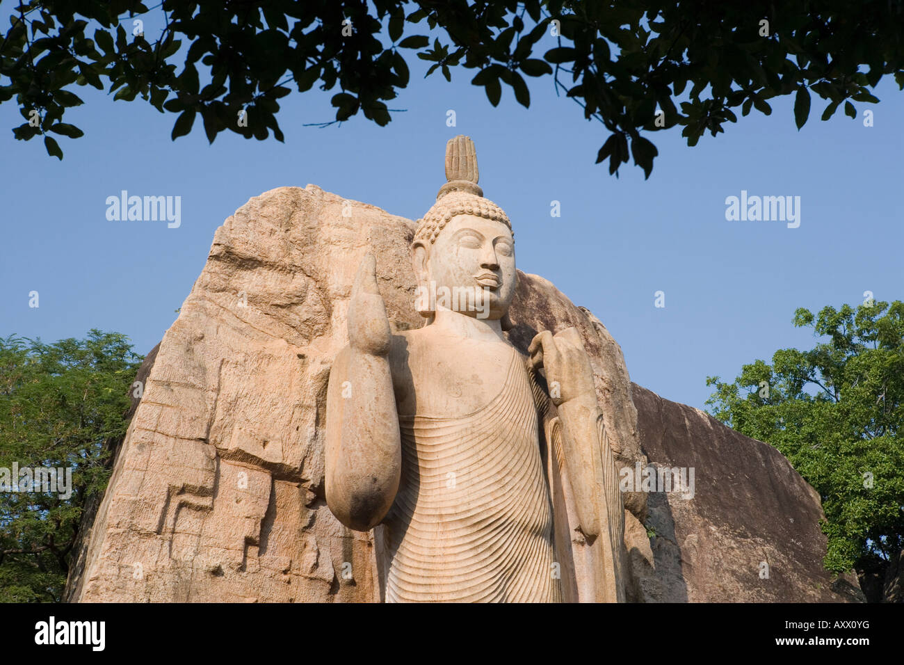 Giant standing statue of the Buddha, the left hand lifting the robe ...
