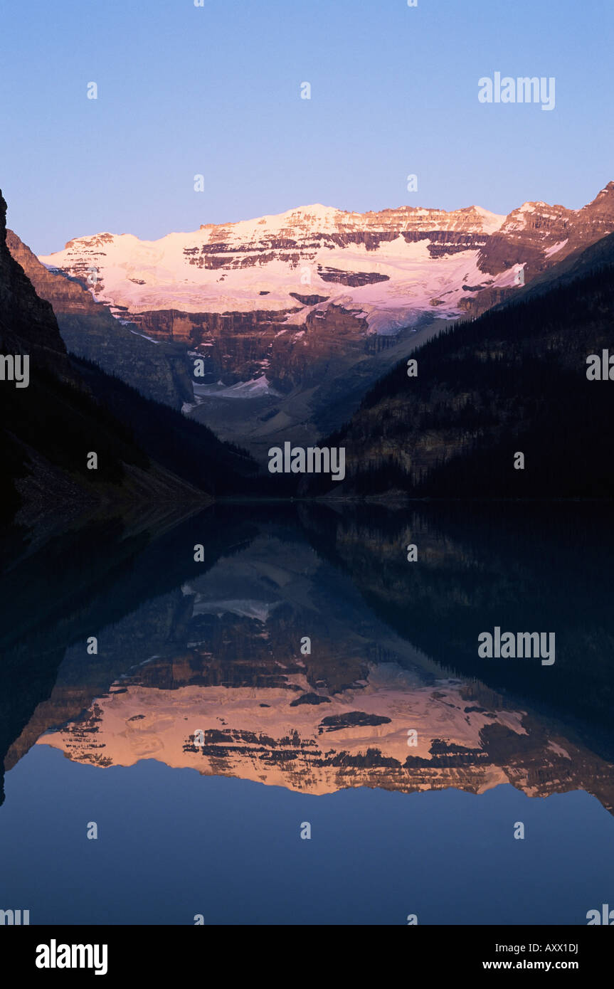 View to Mount Victoria across the still waters of Lake Louise, at ...