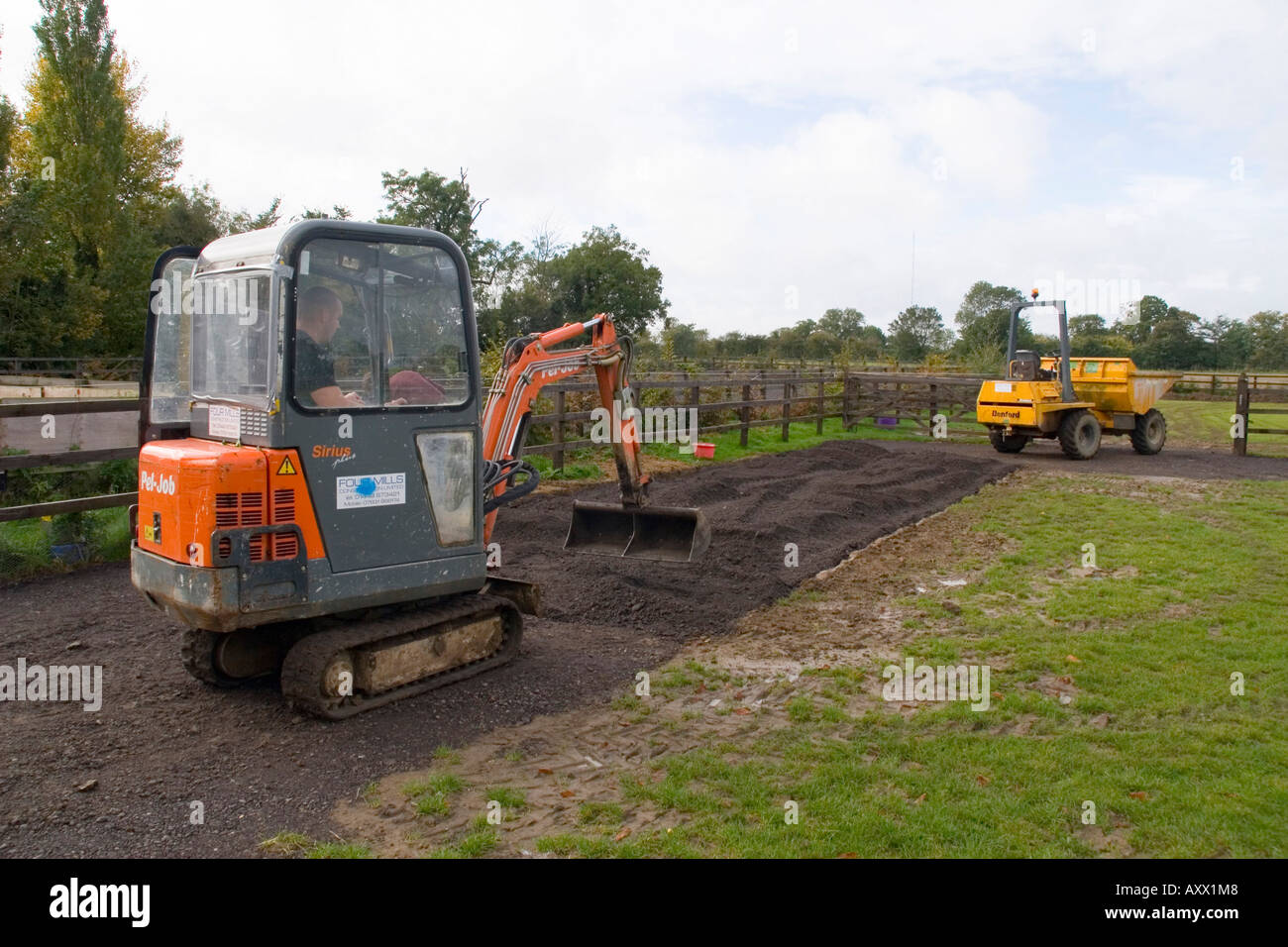 mini digger making hard standing Stock Photo - Alamy