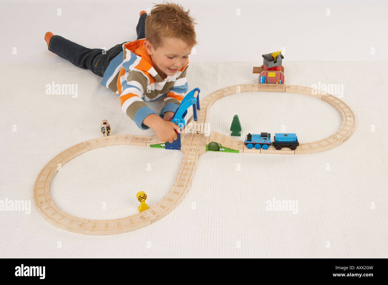 Boy playing with wooden train set at home hi-res stock photography and ...