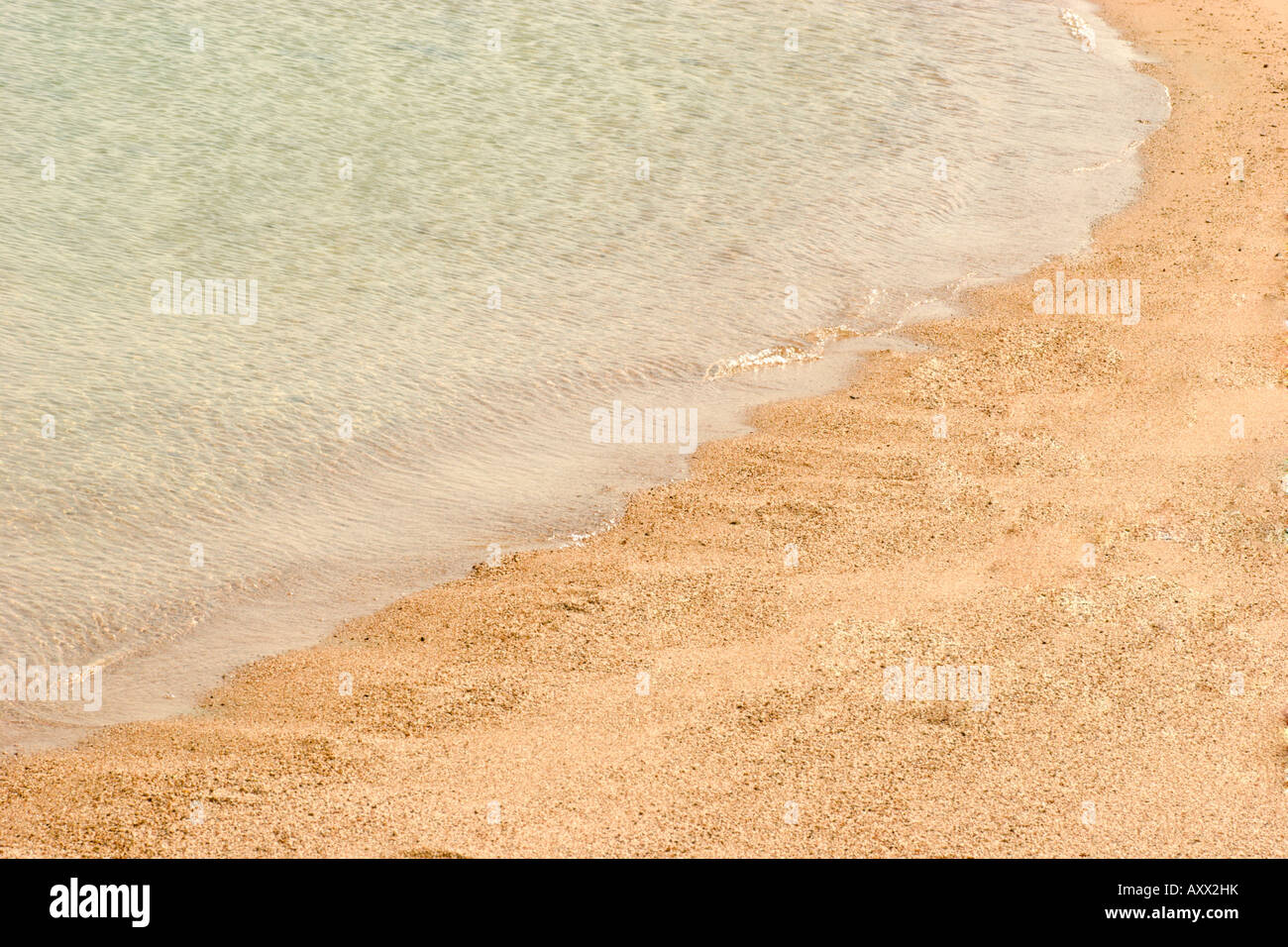 Water s edge beach with golden sand Stock Photo - Alamy