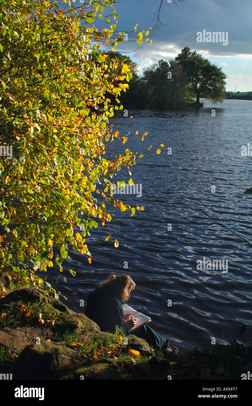 Man Writing Near To The Edge Of A Lake Stock Photo - Alamy