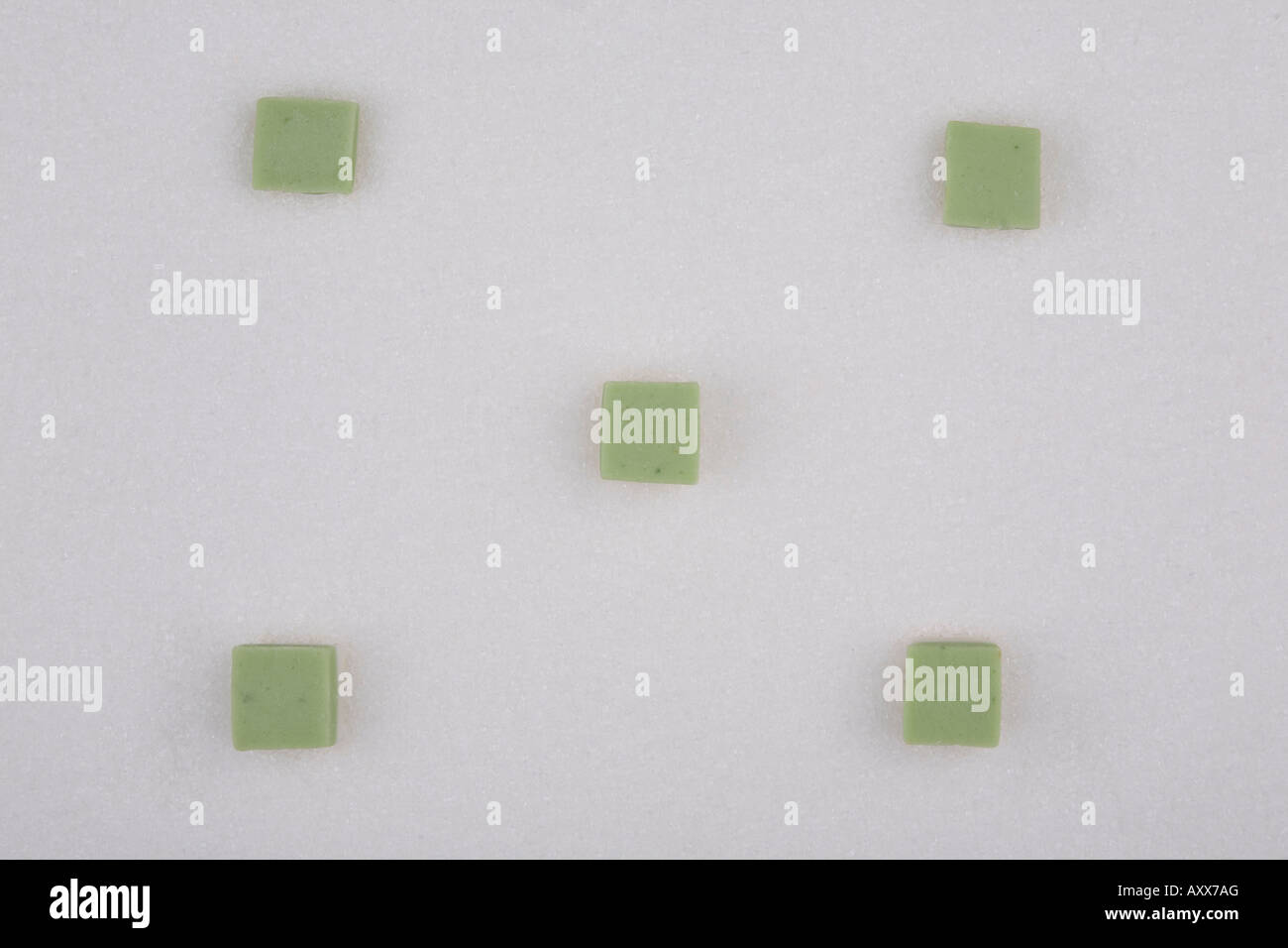 Five pieces of candy on sugar background Stock Photo - Alamy