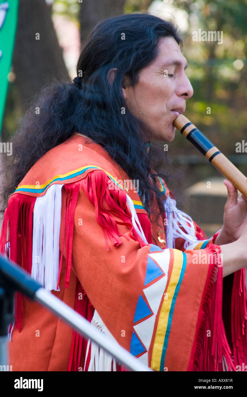 Peruvian man in colorful native costume playing markamasis music with ...