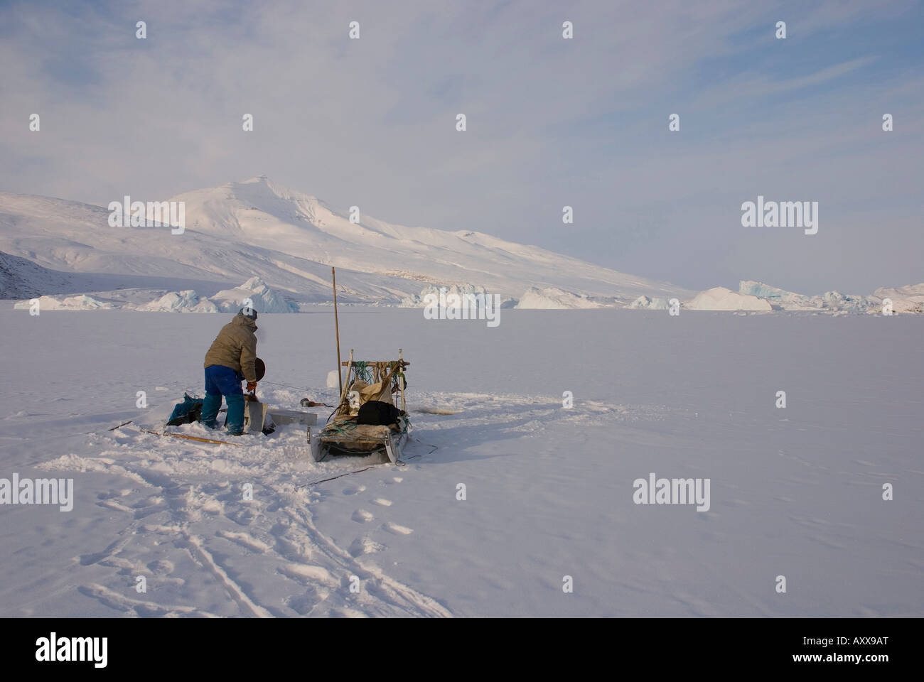 An old inuit fishing through the sea ice in North Greenland Stock Photo ...