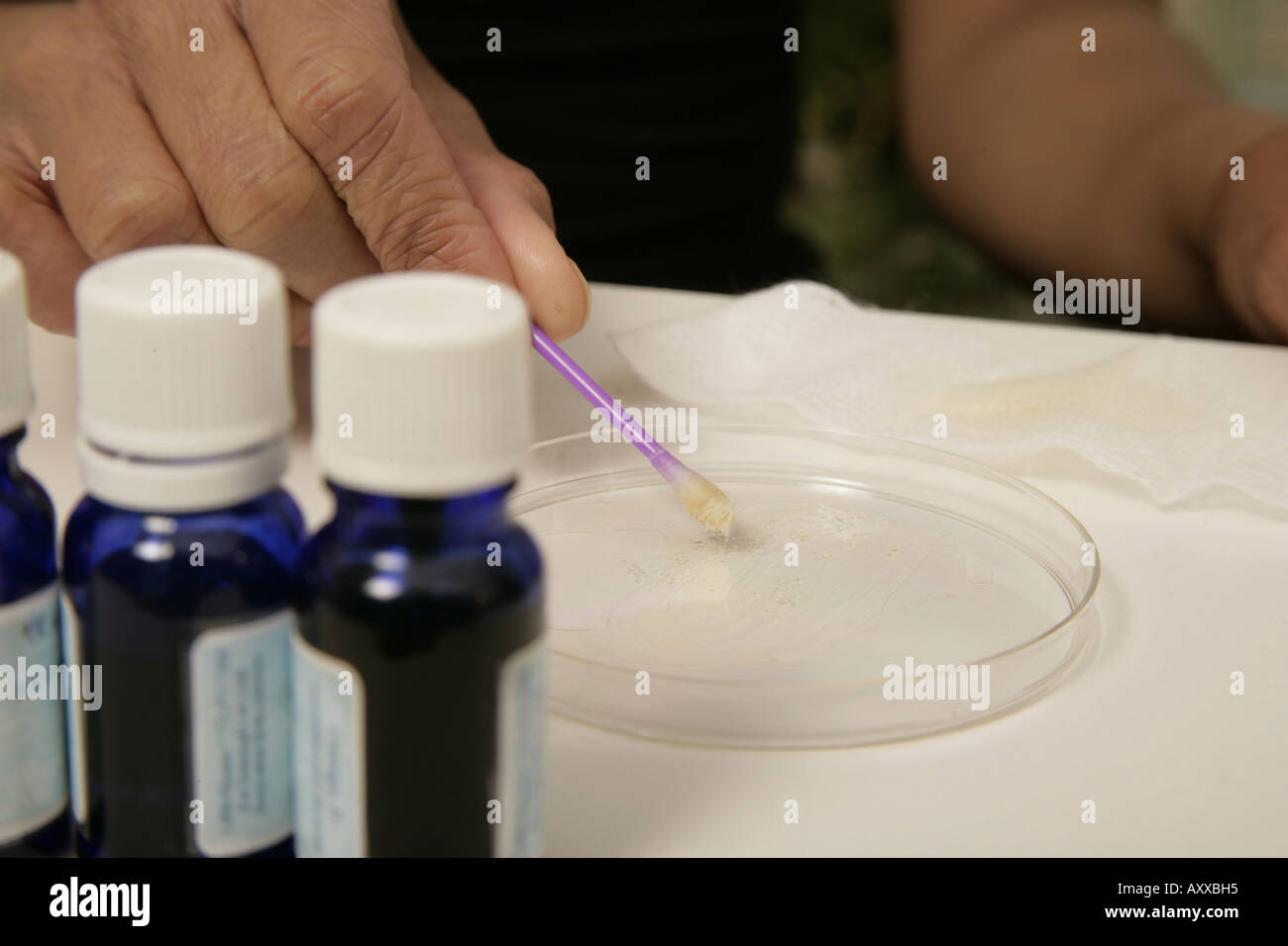 Aromatherapist mixes oils in preparation for use on patient during ...