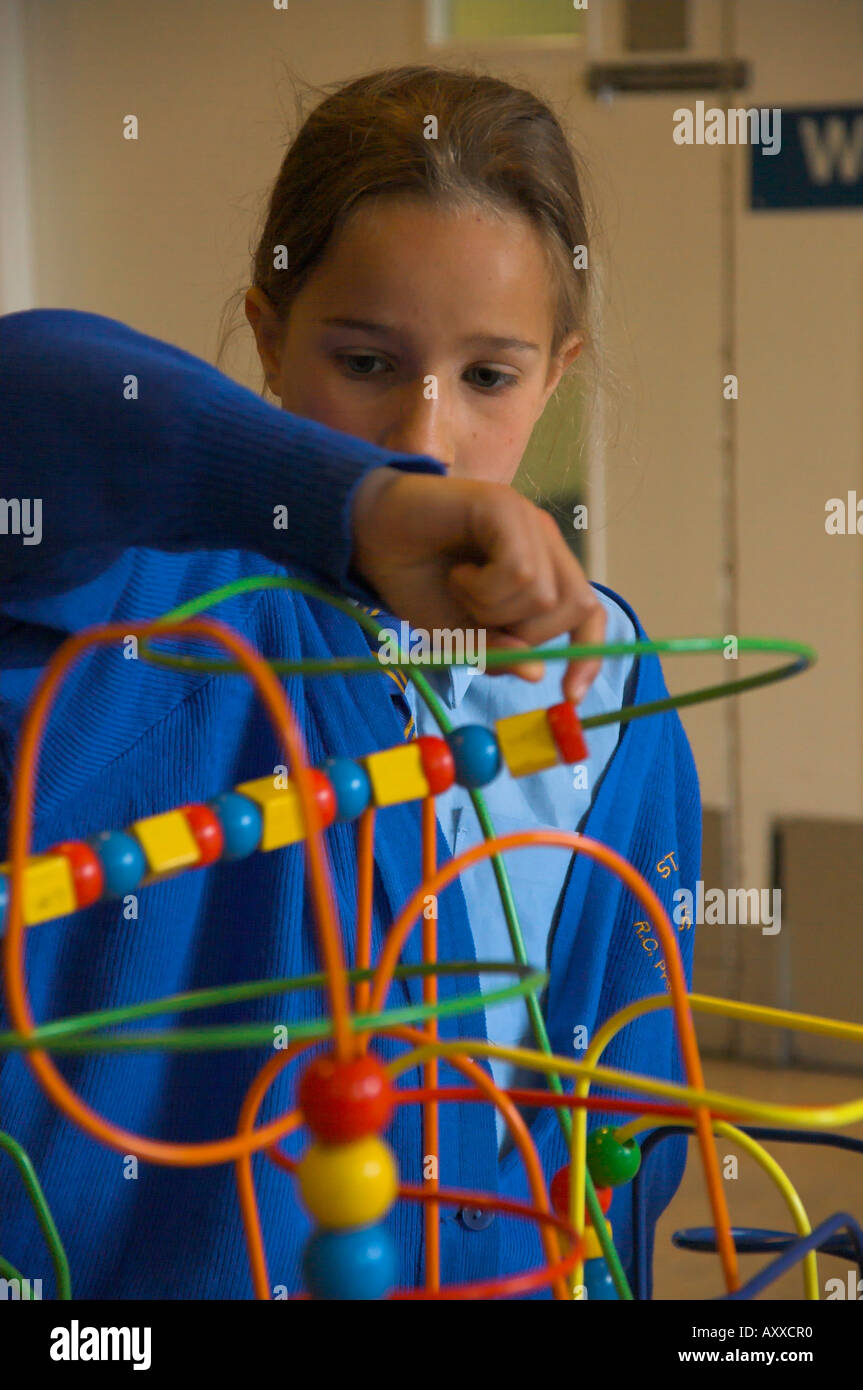 young girl playing with loop toy Stock Photo - Alamy