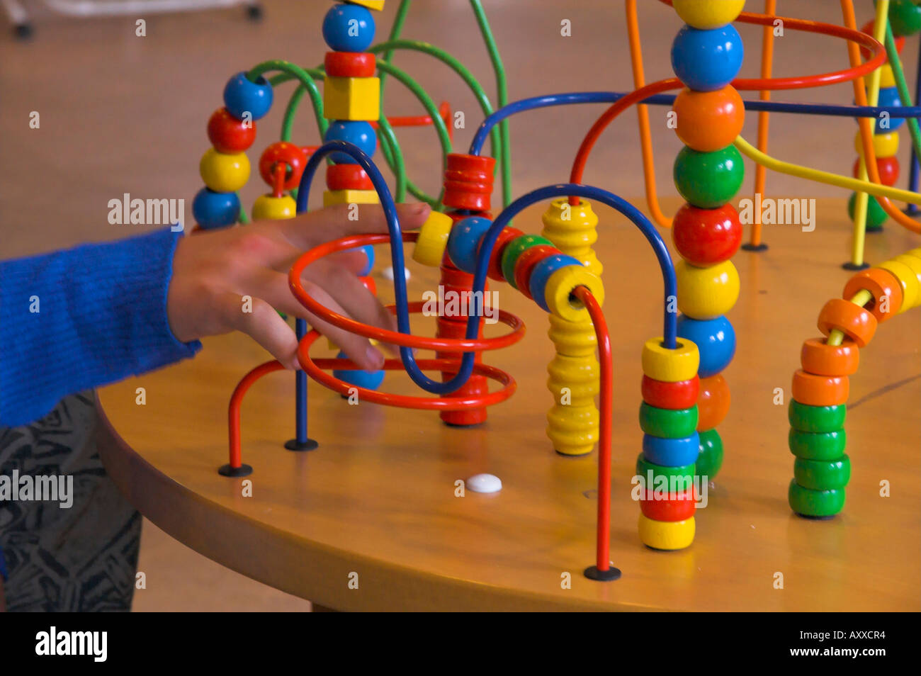 young girl playing with loop toy Stock Photo - Alamy