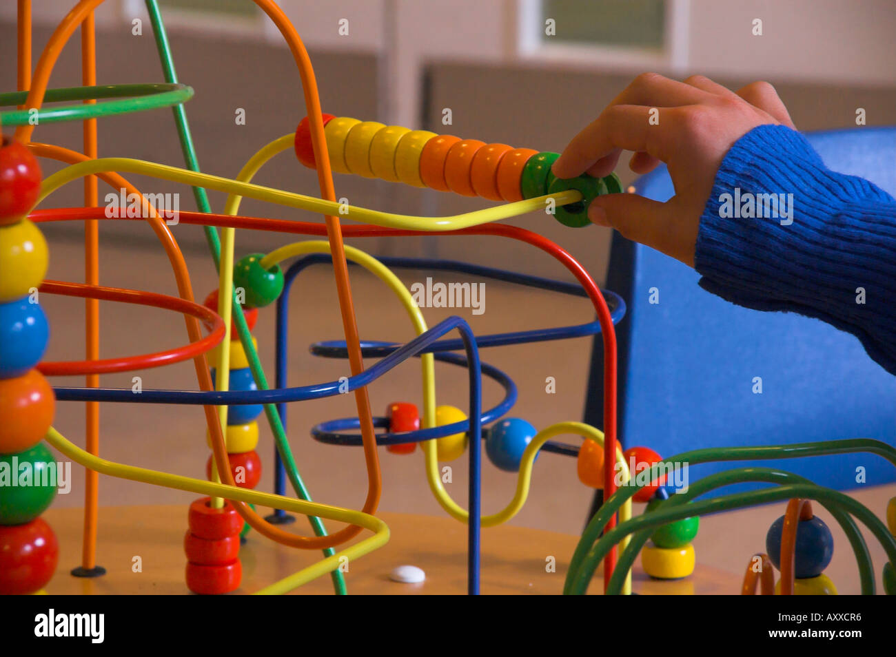 young girl playing with loop toy Stock Photo - Alamy
