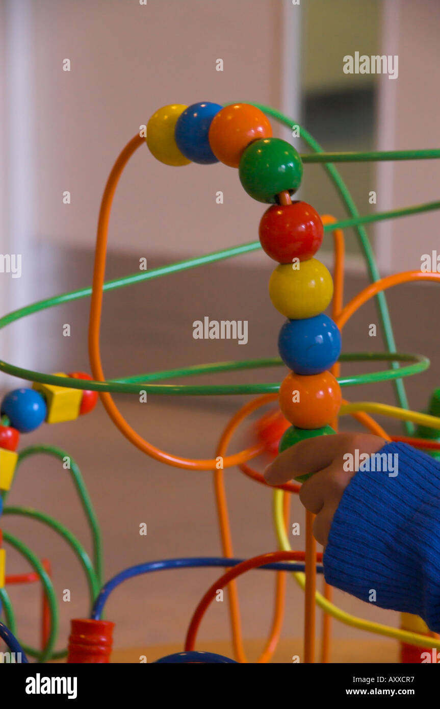 young girl playing with loop toy Stock Photo - Alamy