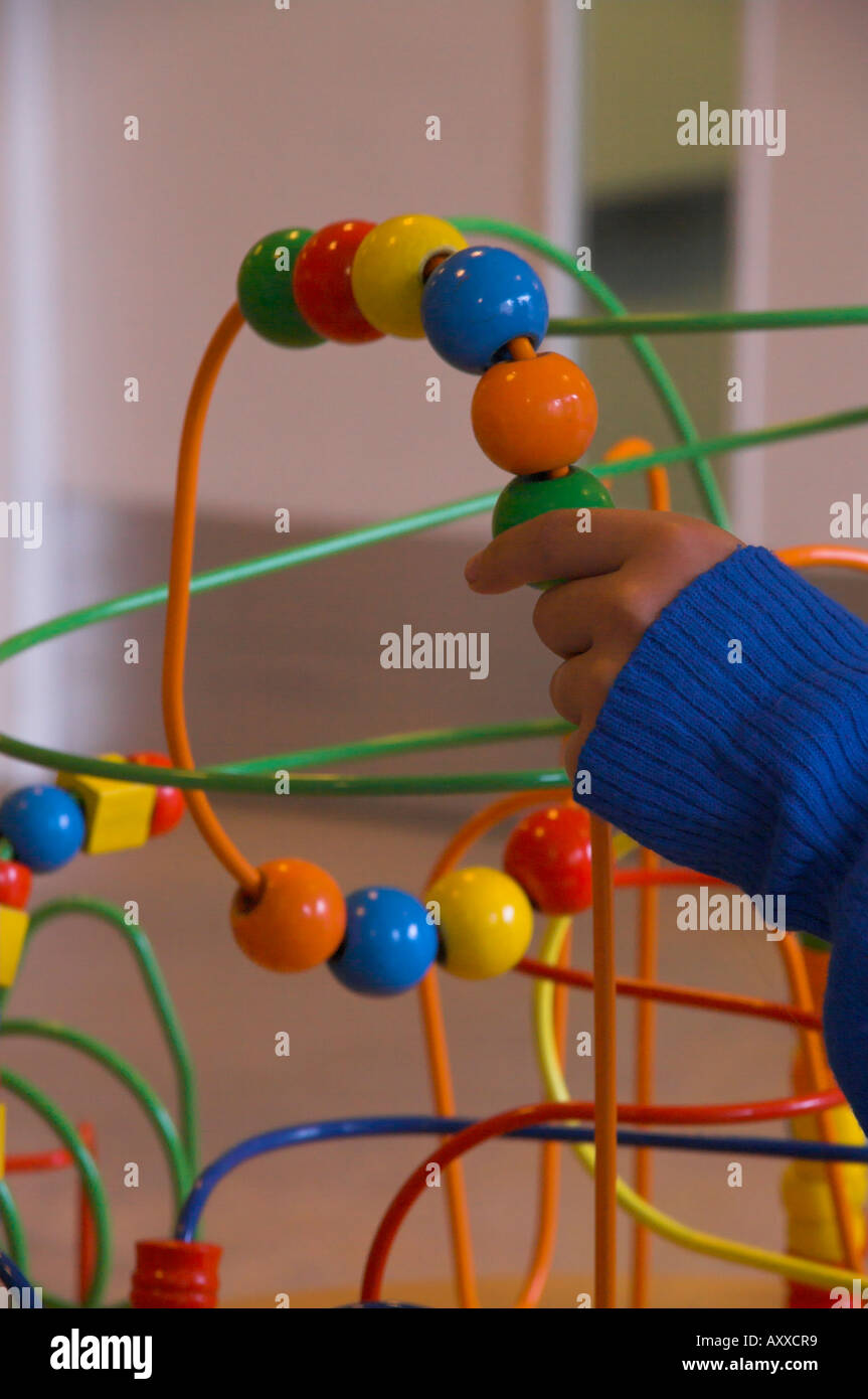 young girl playing with loop toy Stock Photo - Alamy
