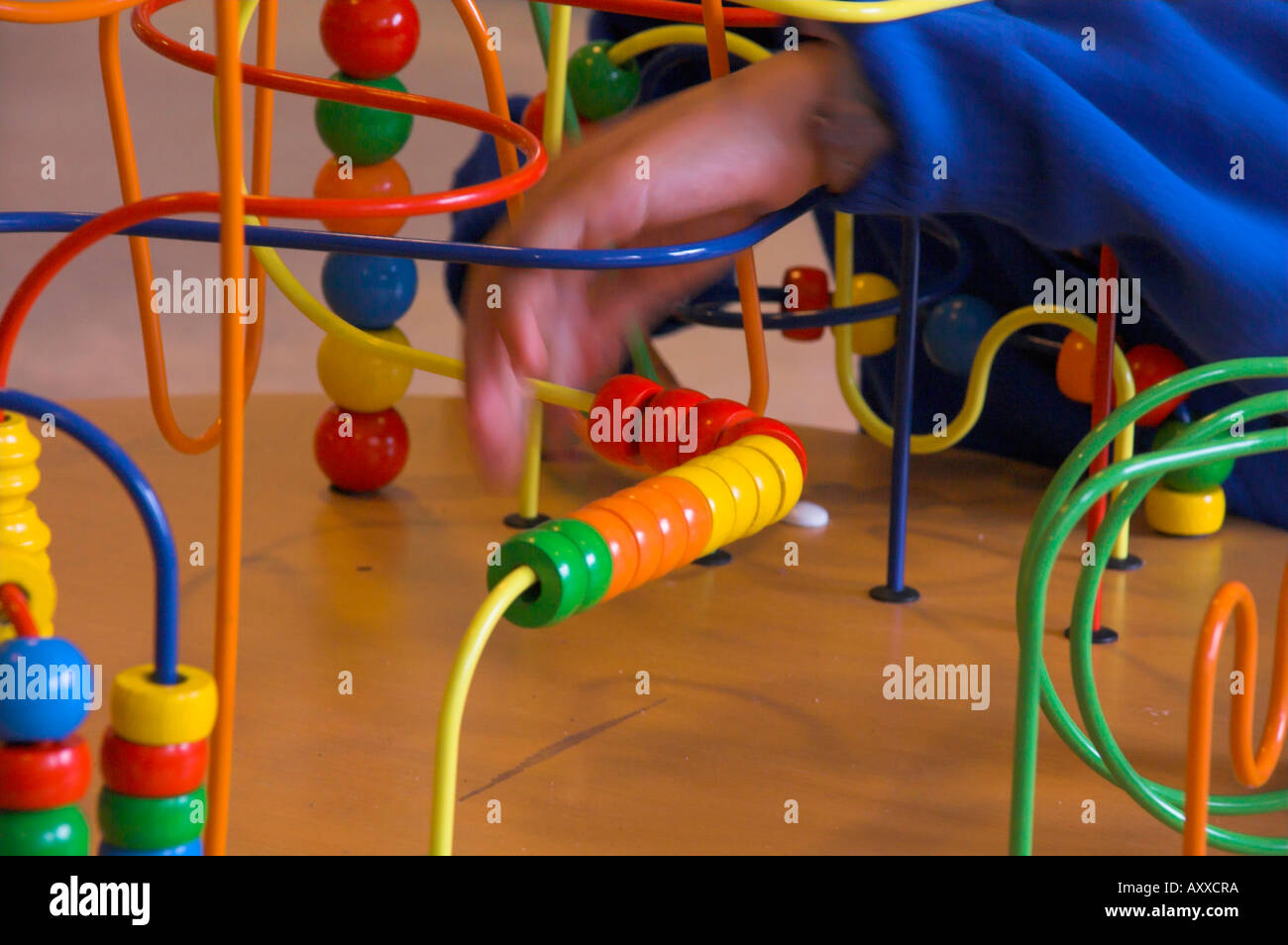 young girl playing with loop toy Stock Photo - Alamy