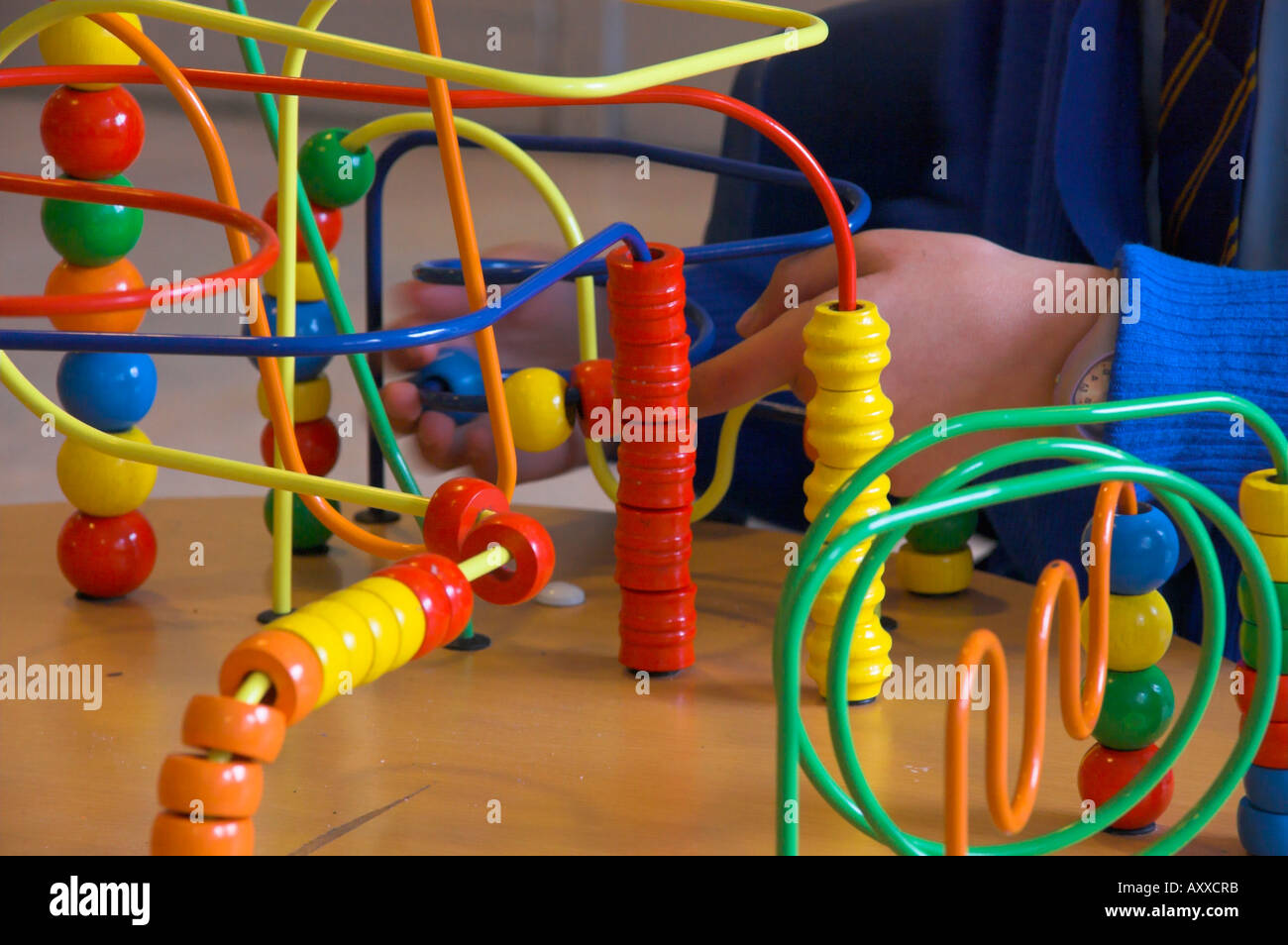 young girl playing with loop toy Stock Photo - Alamy