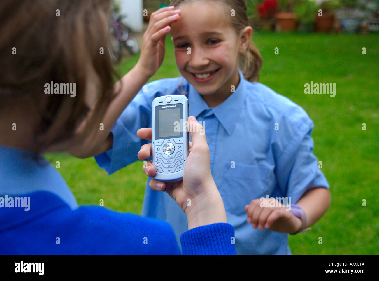 young girls smiling cheekily photographed by mobile phone camera Stock ...